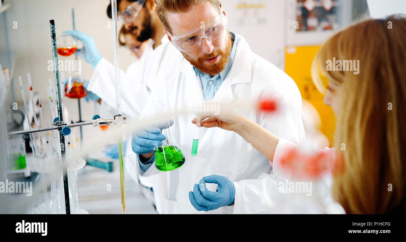 Group of chemistry students working in laboratory Stock Photo - Alamy