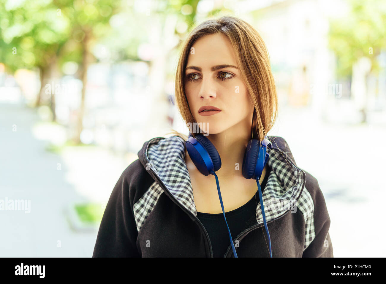 Closeup view of teenage girl carrying headphones around the neck Stock ...