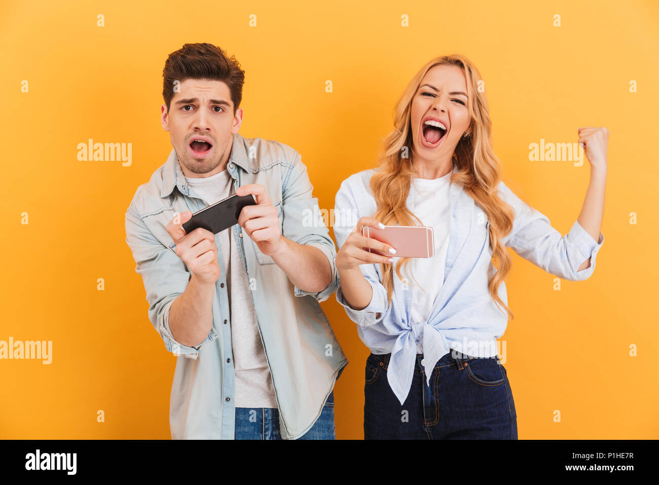 Image of loser man and winning woman playing together and competing in ...