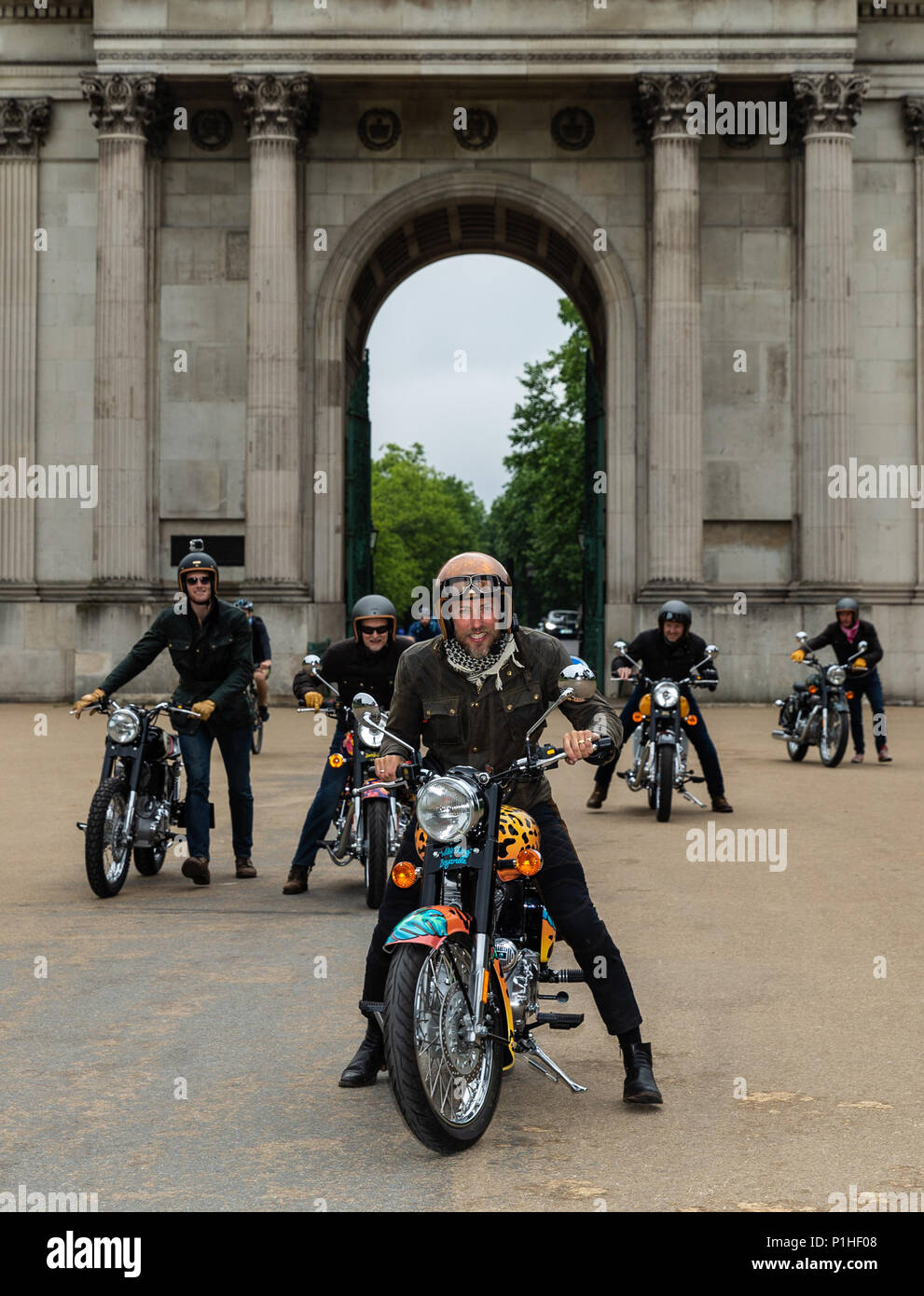 Sam Pelly riding the Boyarde bike leading the customised Royal Enfield ...