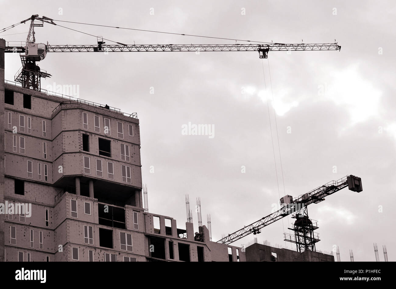 Working tall cranes inside place for with tall buildings under ...