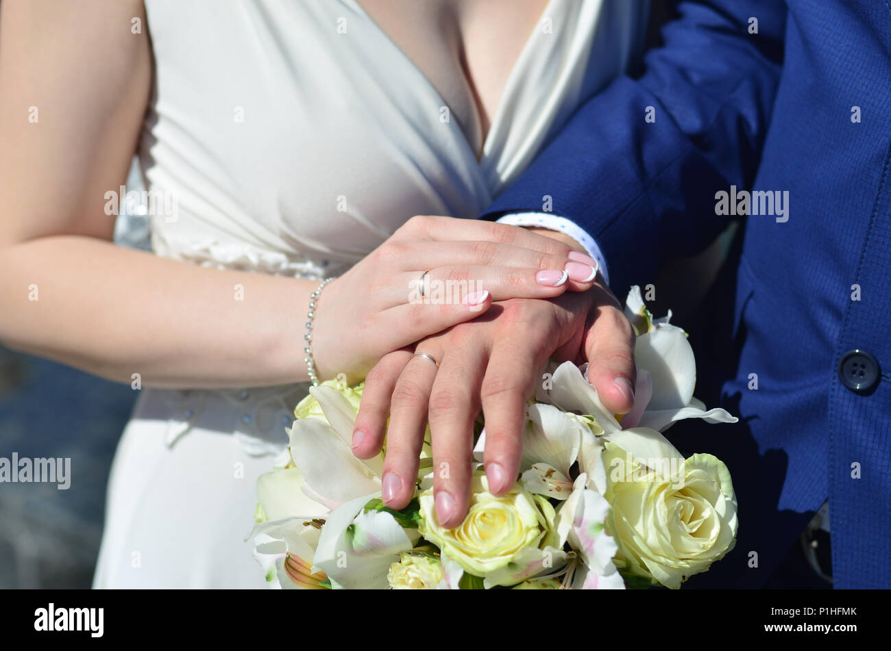 The newlywed couple is holding a beautiful wedding bouquet. Classical ...