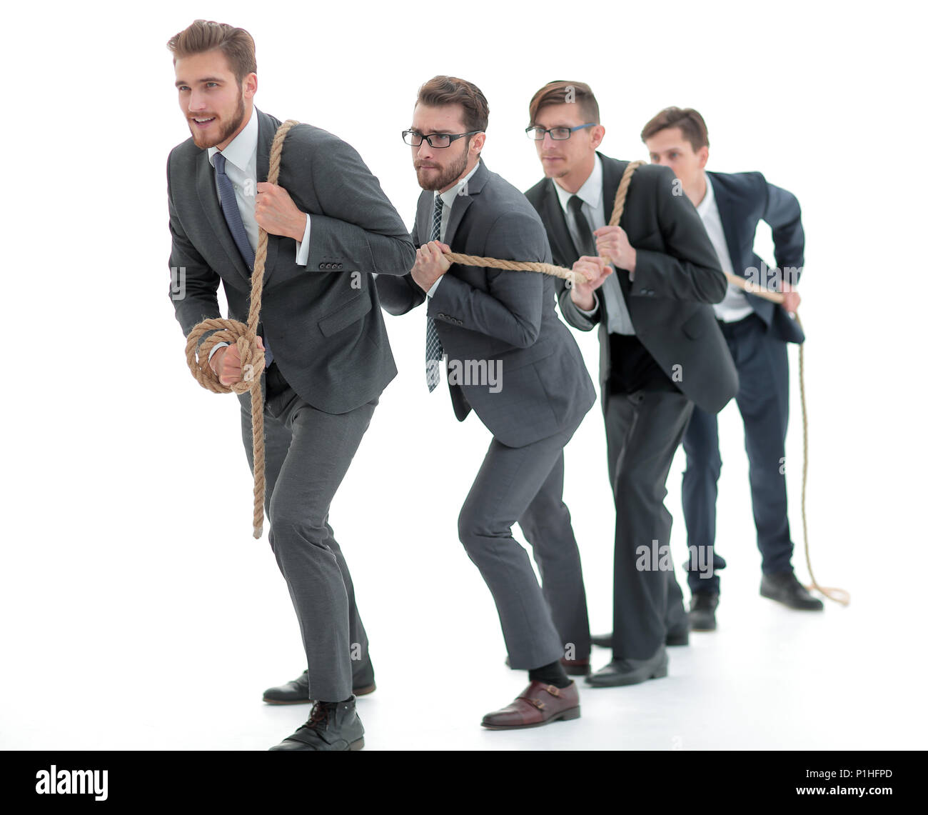 closeup.smiling business team pulls the rope Stock Photo - Alamy