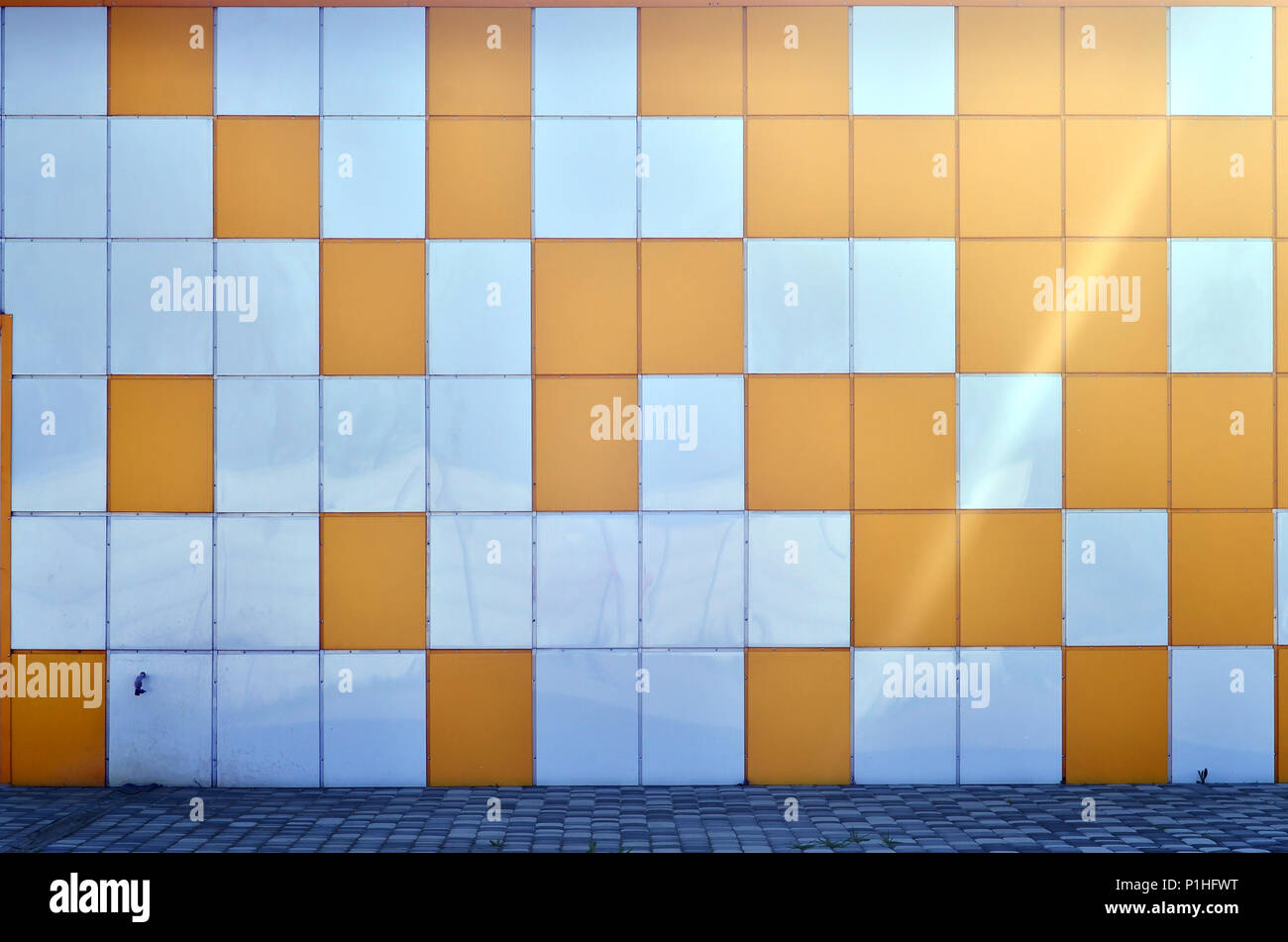 The texture of the metal wall, framed in the form of colored squares of ...