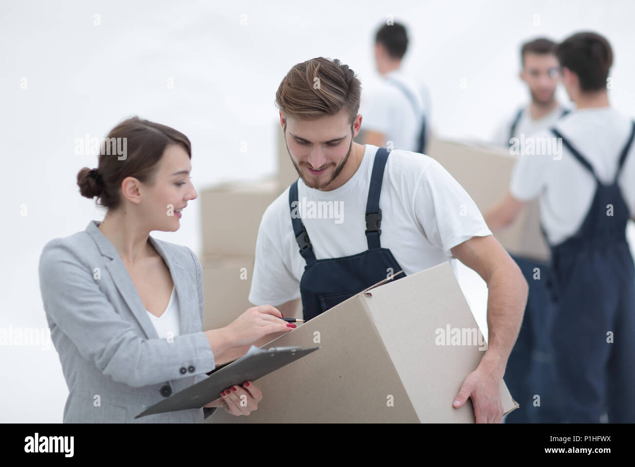 Manager and movers isolated on white background Stock Photo - Alamy
