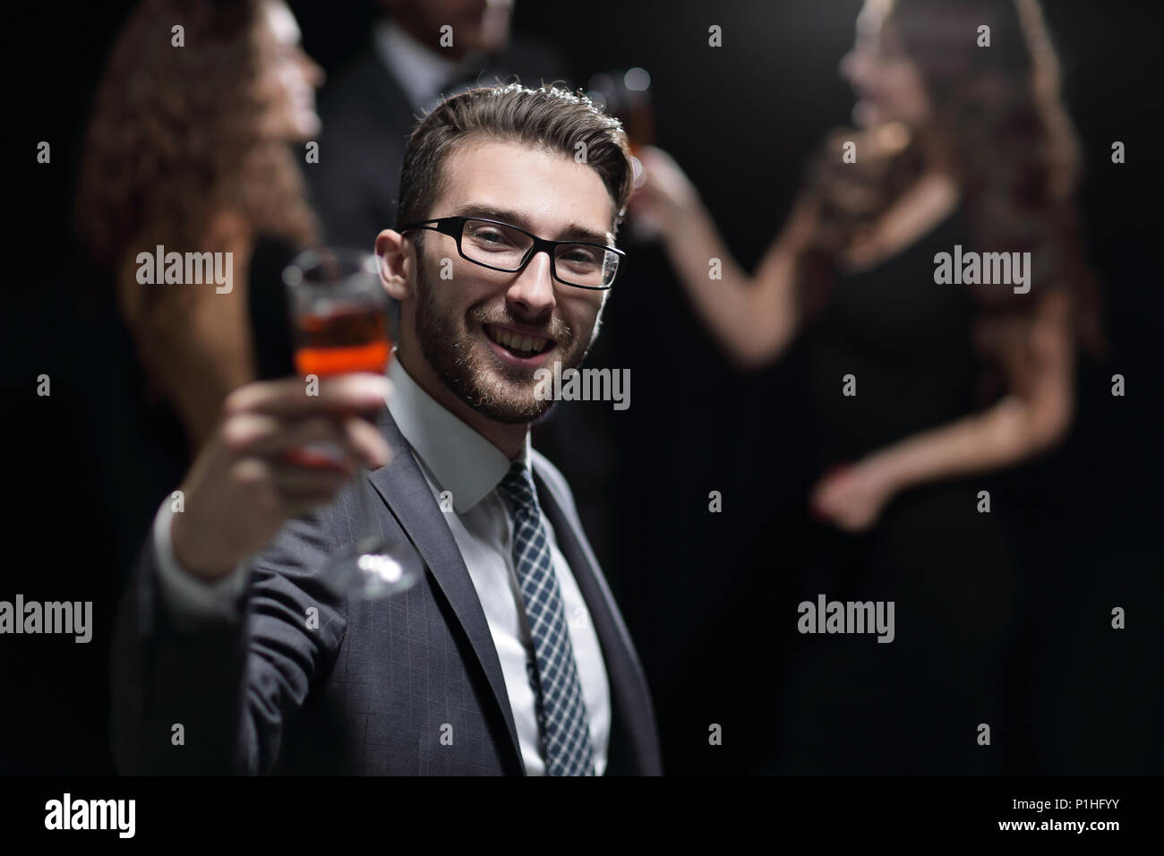 elegant man raising his glass with the toast Stock Photo - Alamy