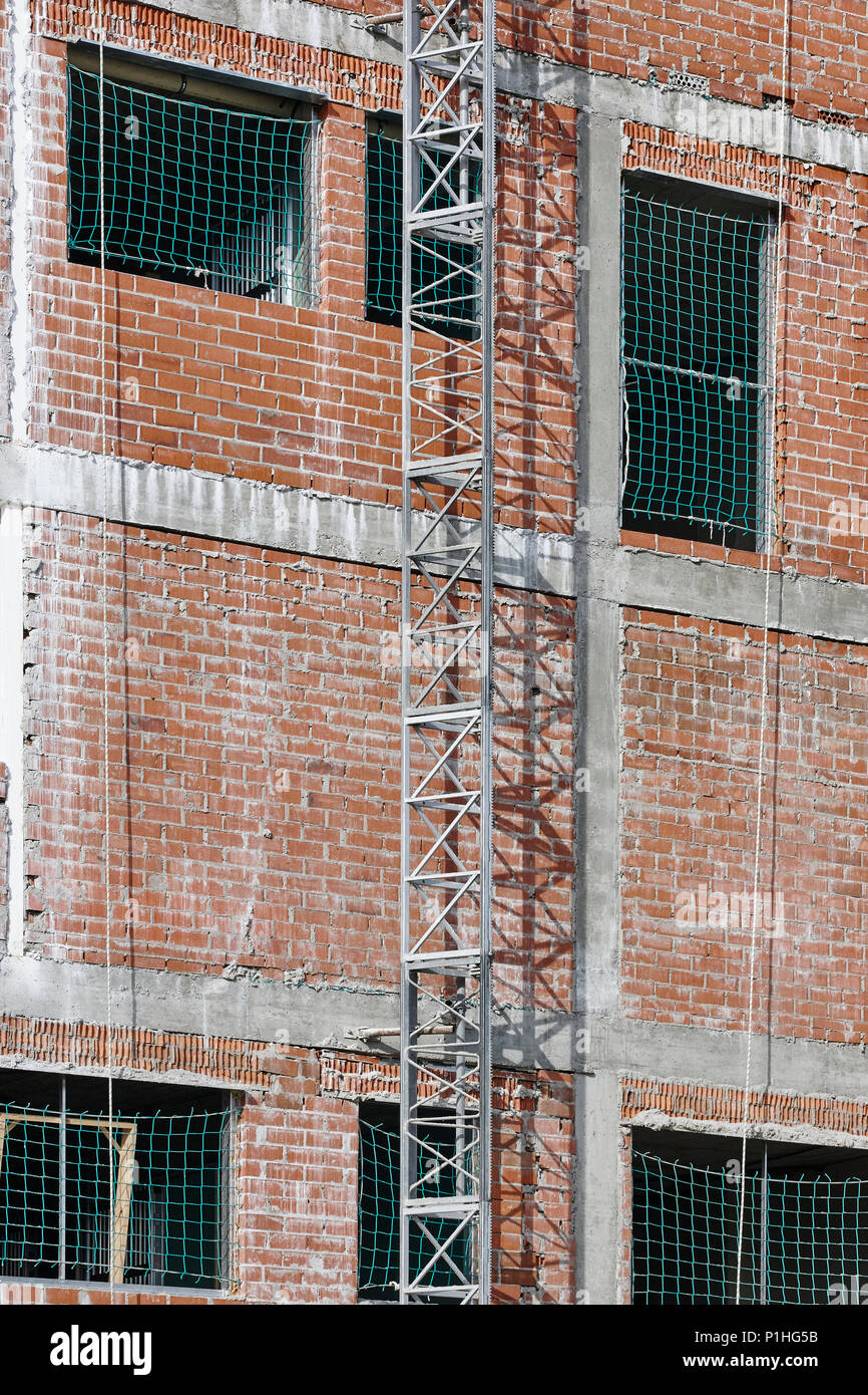 Building under construction. Brick facade structure. Architecture ...