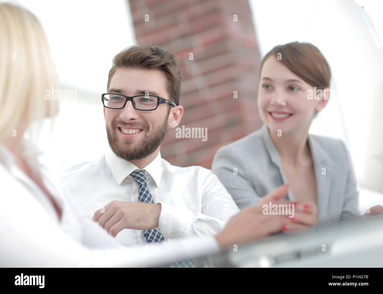 business team talking while sitting at your Desk Stock Photo - Alamy