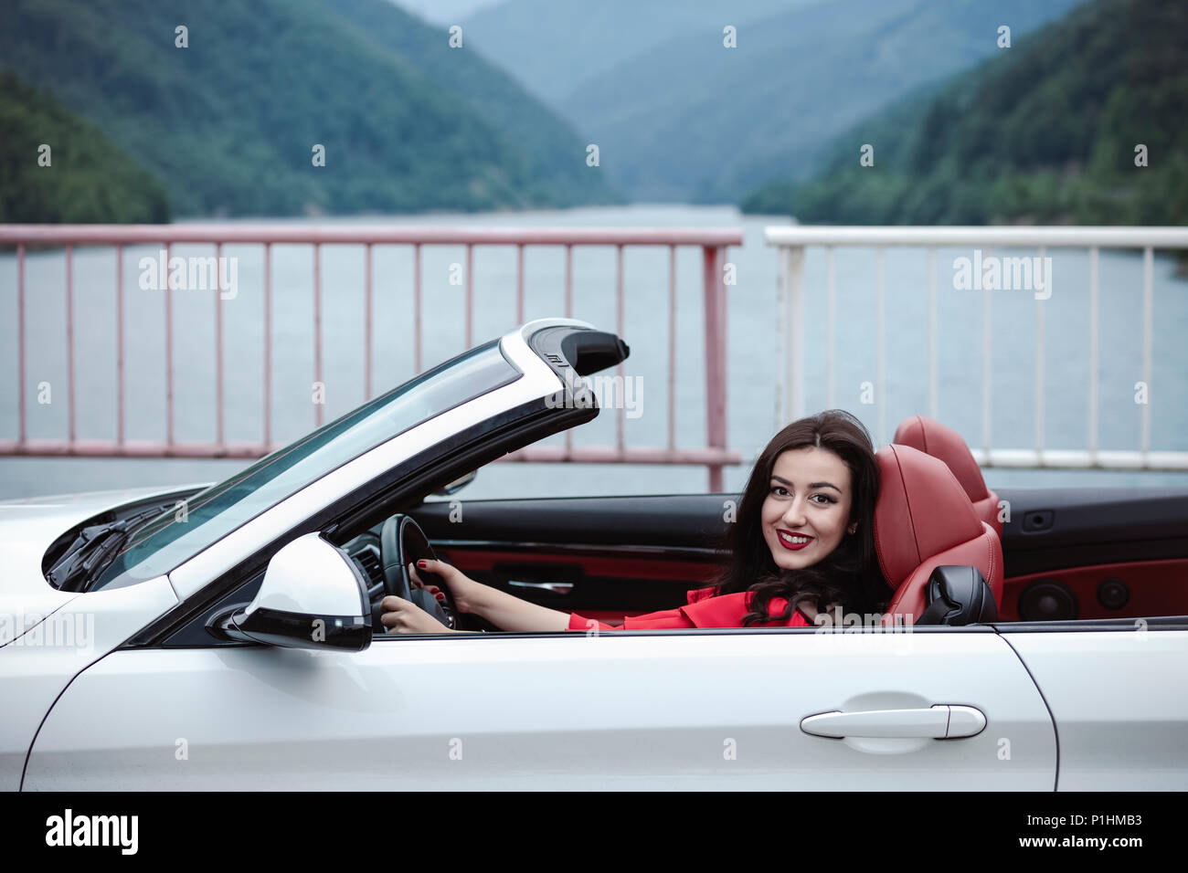 Beautiful young woman in a convertible car enjoying a summer day Stock ...