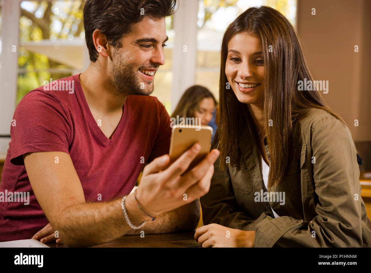 Happy female friends watching sharing hi-res stock photography and ...