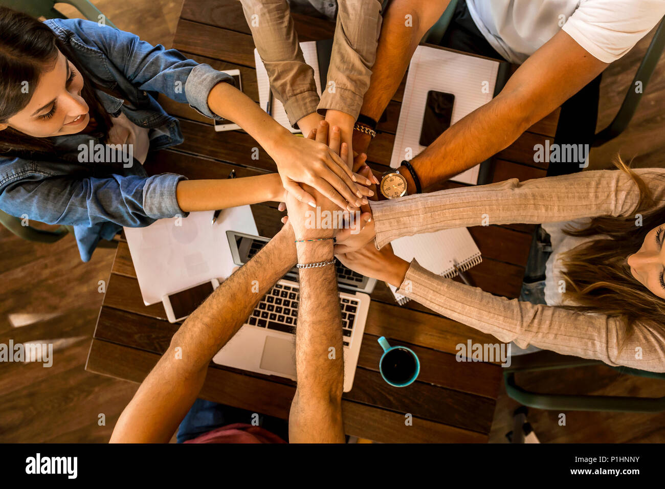 Friends hands together teamwork unity hi-res stock photography and ...