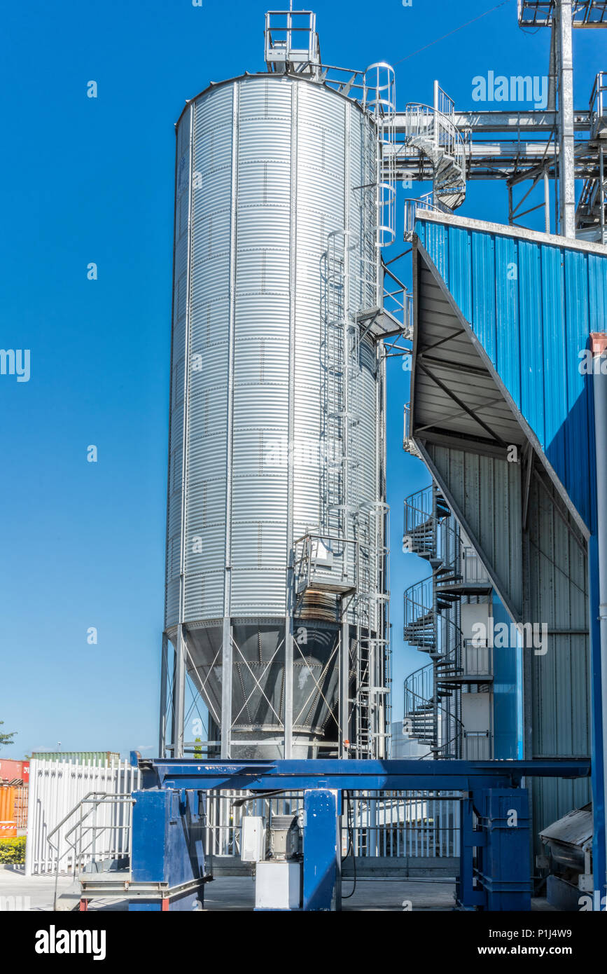 Beverage factory cylinders. With blue sky Stock Photo - Alamy