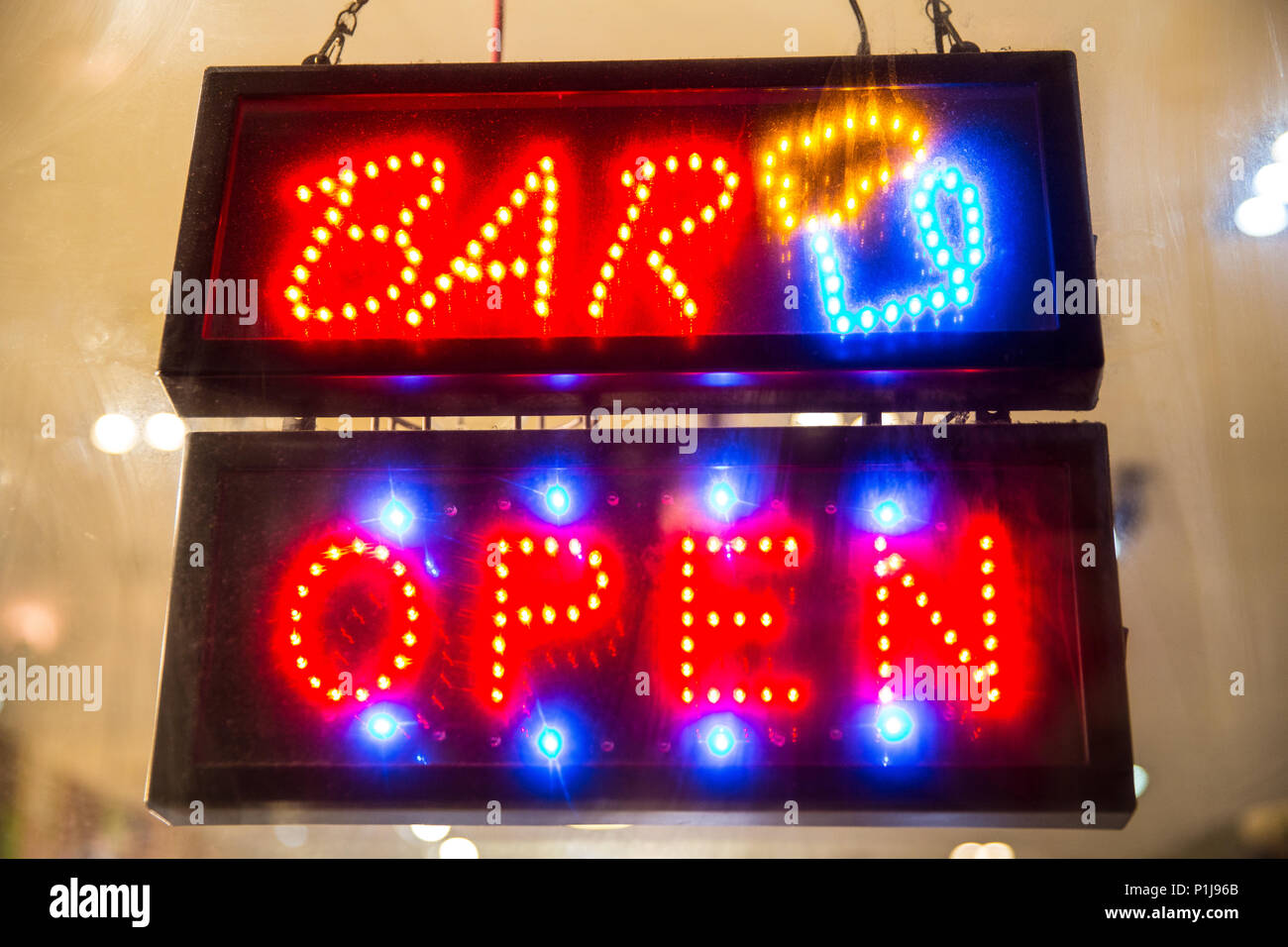 A bar open sign lit up at night with LED lights on a London Street iin ...