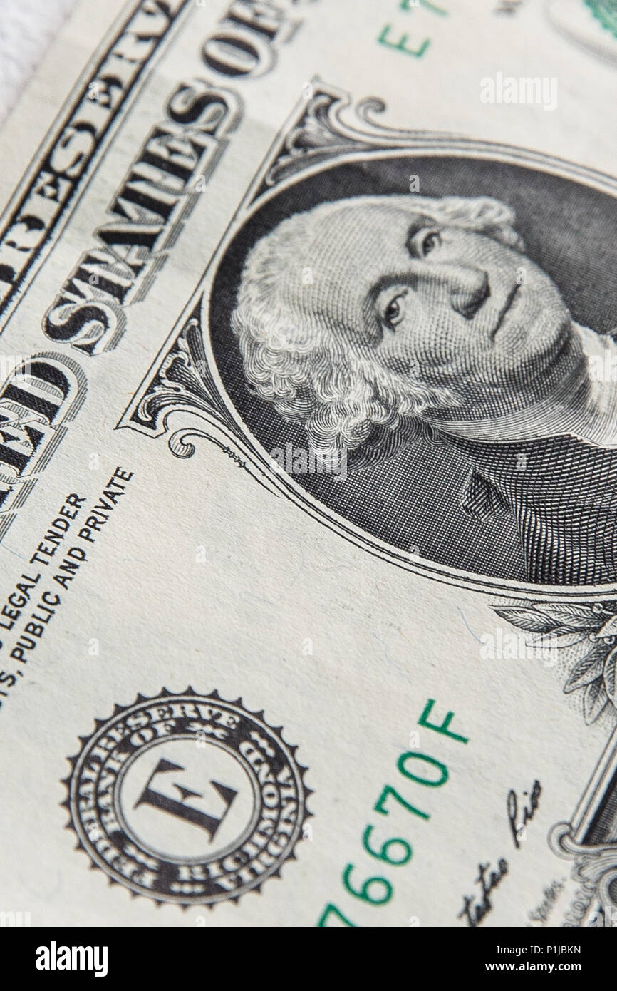 A pile of US one dollar notes and English ten pound notes in a pile on ...