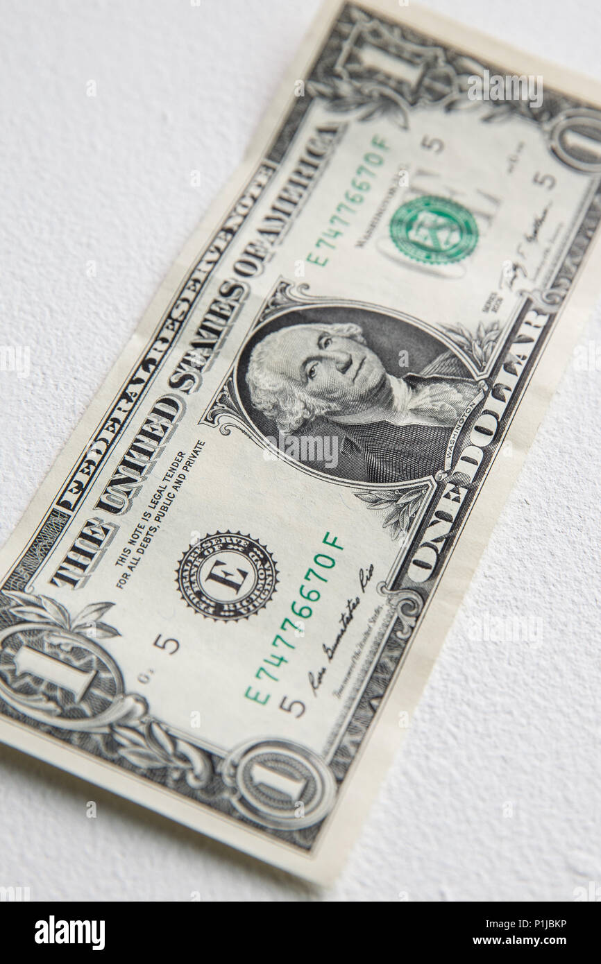 A pile of US one dollar notes and English ten pound notes in a pile on ...