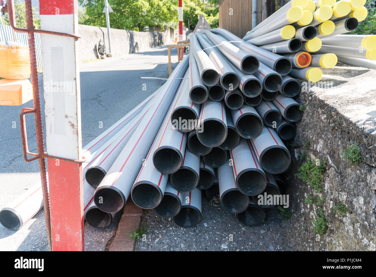 stack of pipes used for plumbing and city water services ready for ...