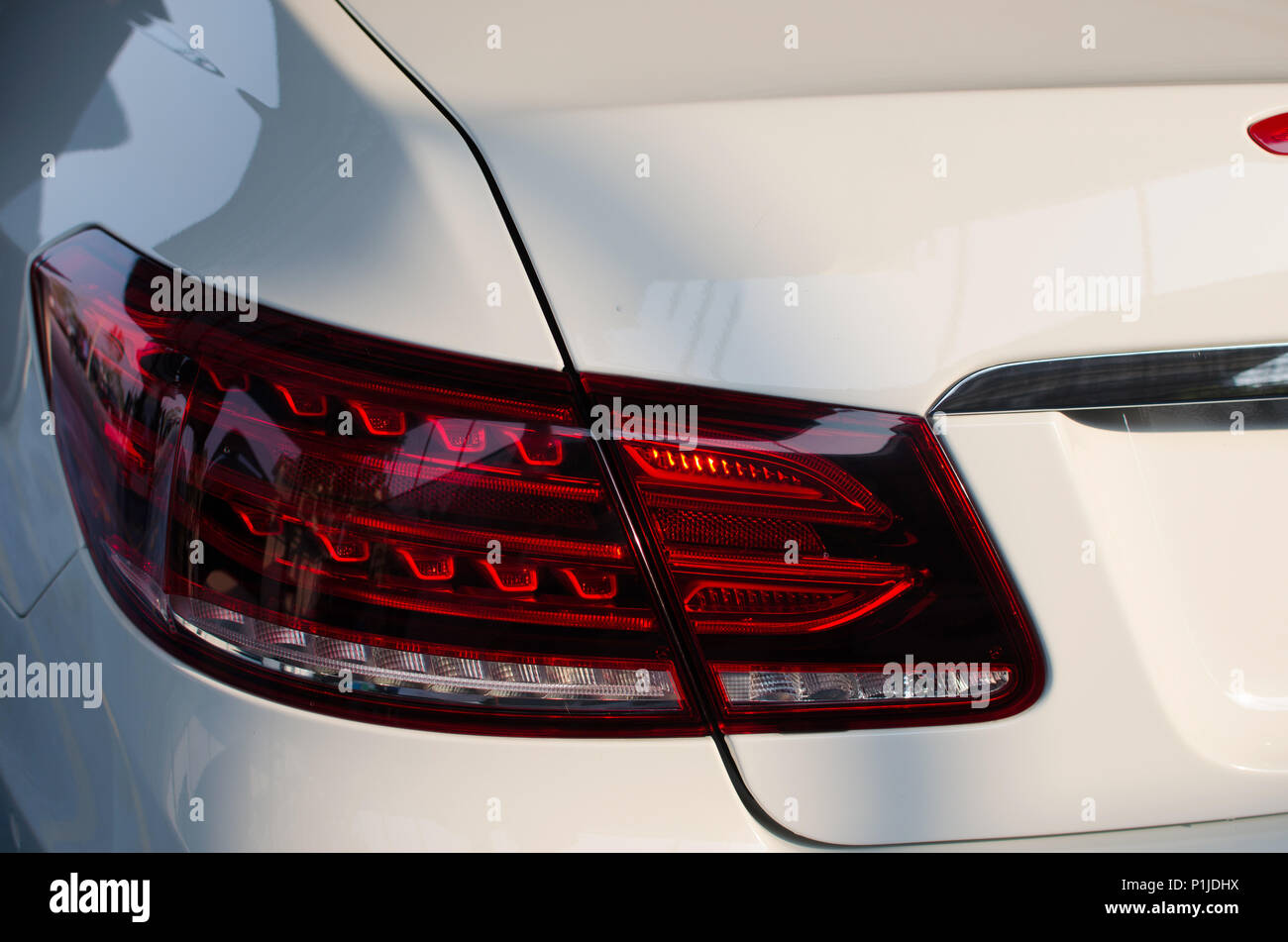 Tail light on white car Stock Photo - Alamy