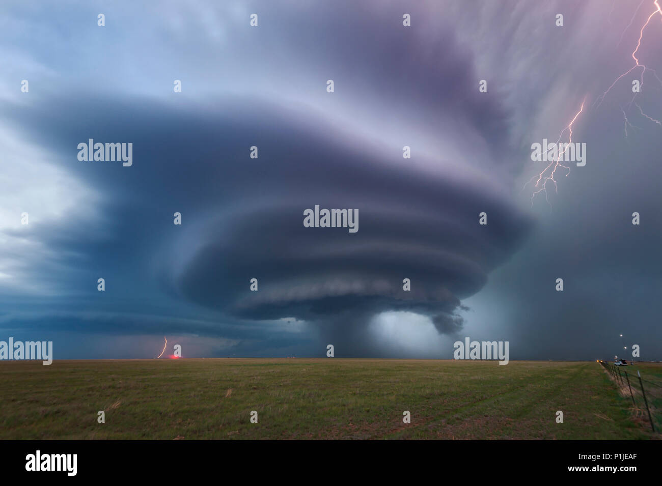 Supercell lightnings during sunset above field vega hi-res stock ...