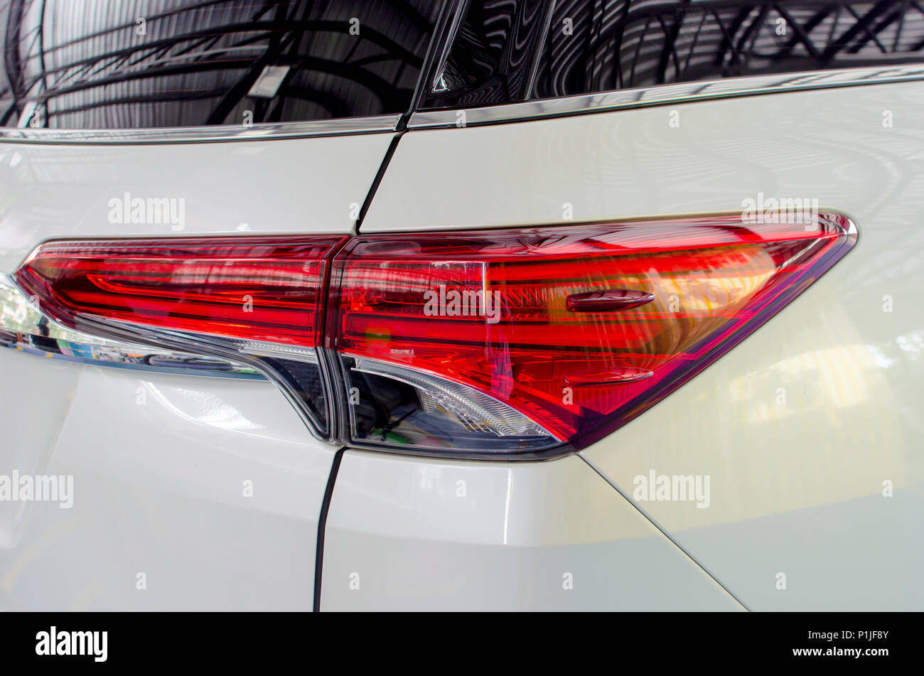Tail light on white car Stock Photo - Alamy