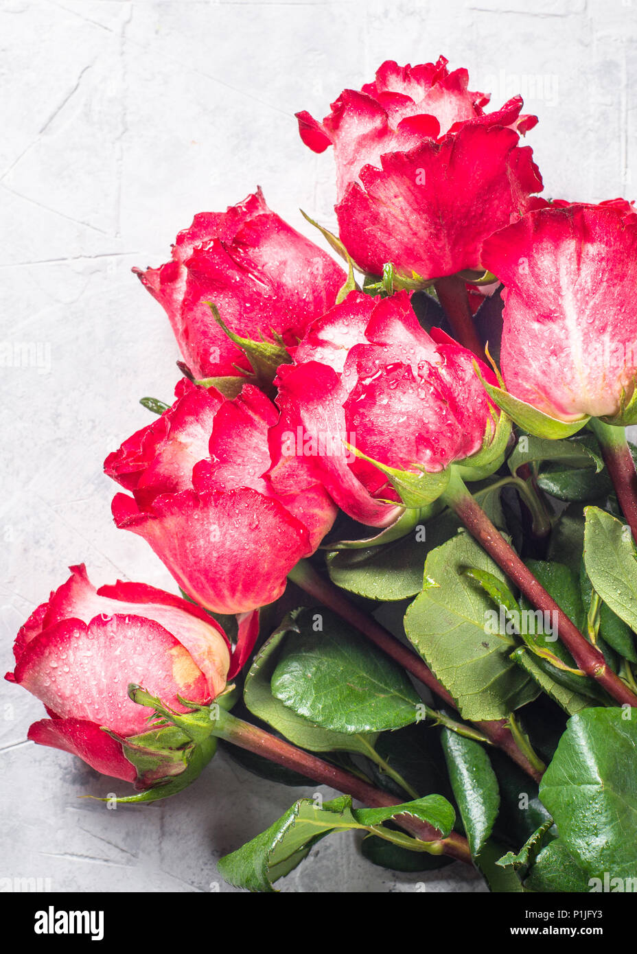 Red rose flower bouquet on stone table. Top view vertical Stock Photo ...