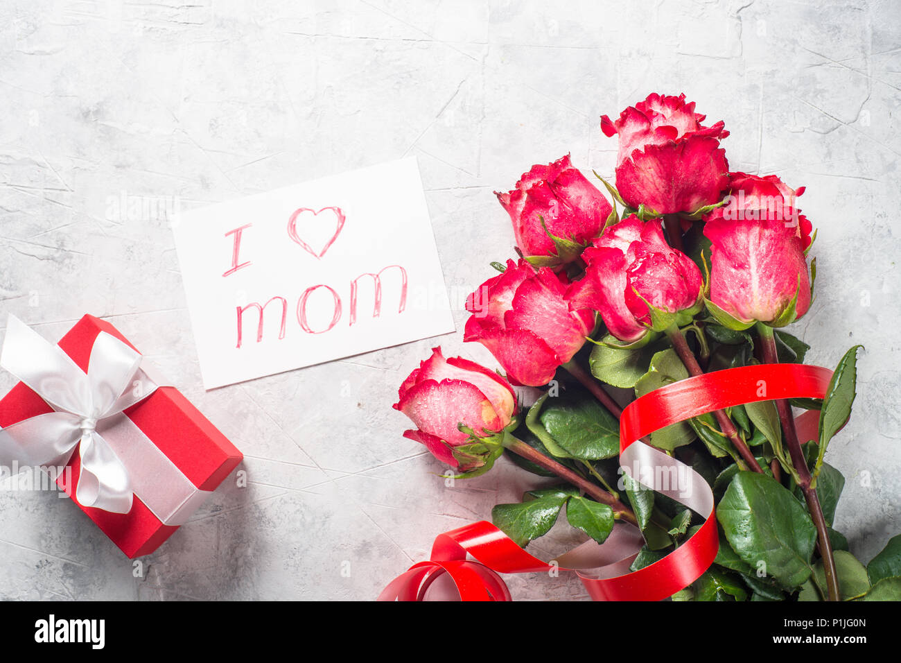 Mother's day background. Red rose flower bouquet with present and ...