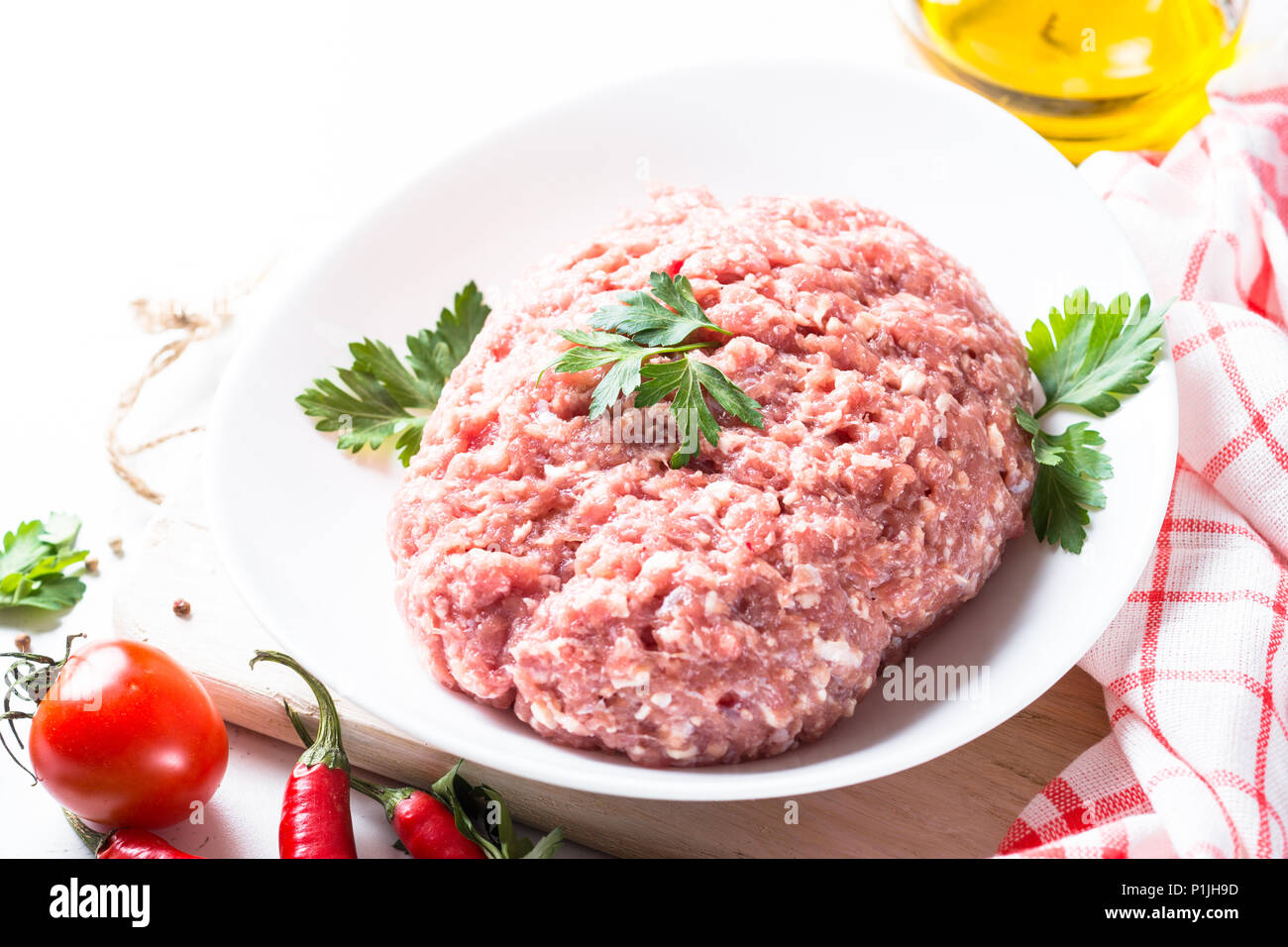 Minced meat with ingredients for cooking on white table Stock Photo - Alamy