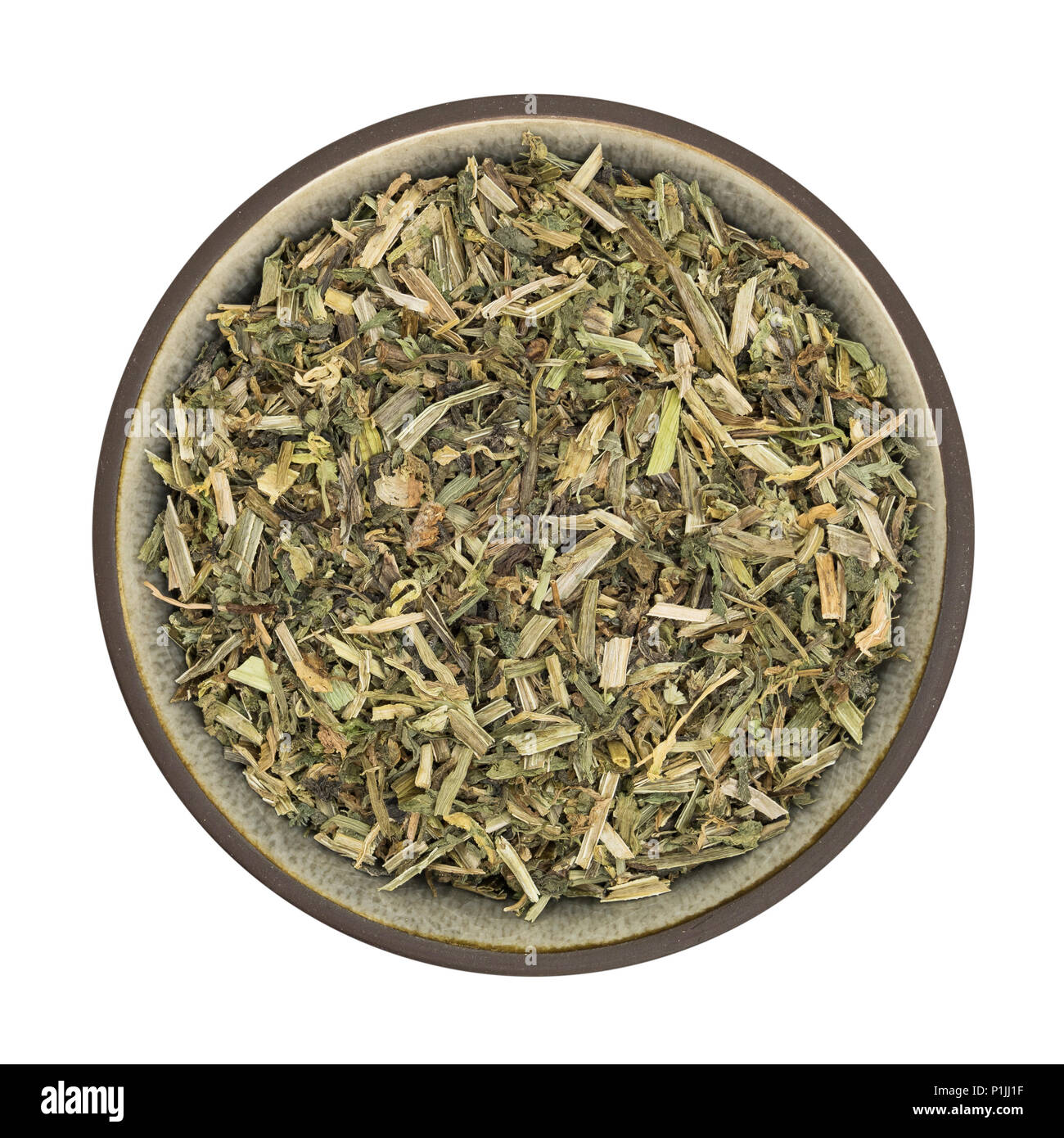 Organic dried cleavers in ceramic bowl isolated on white background ...