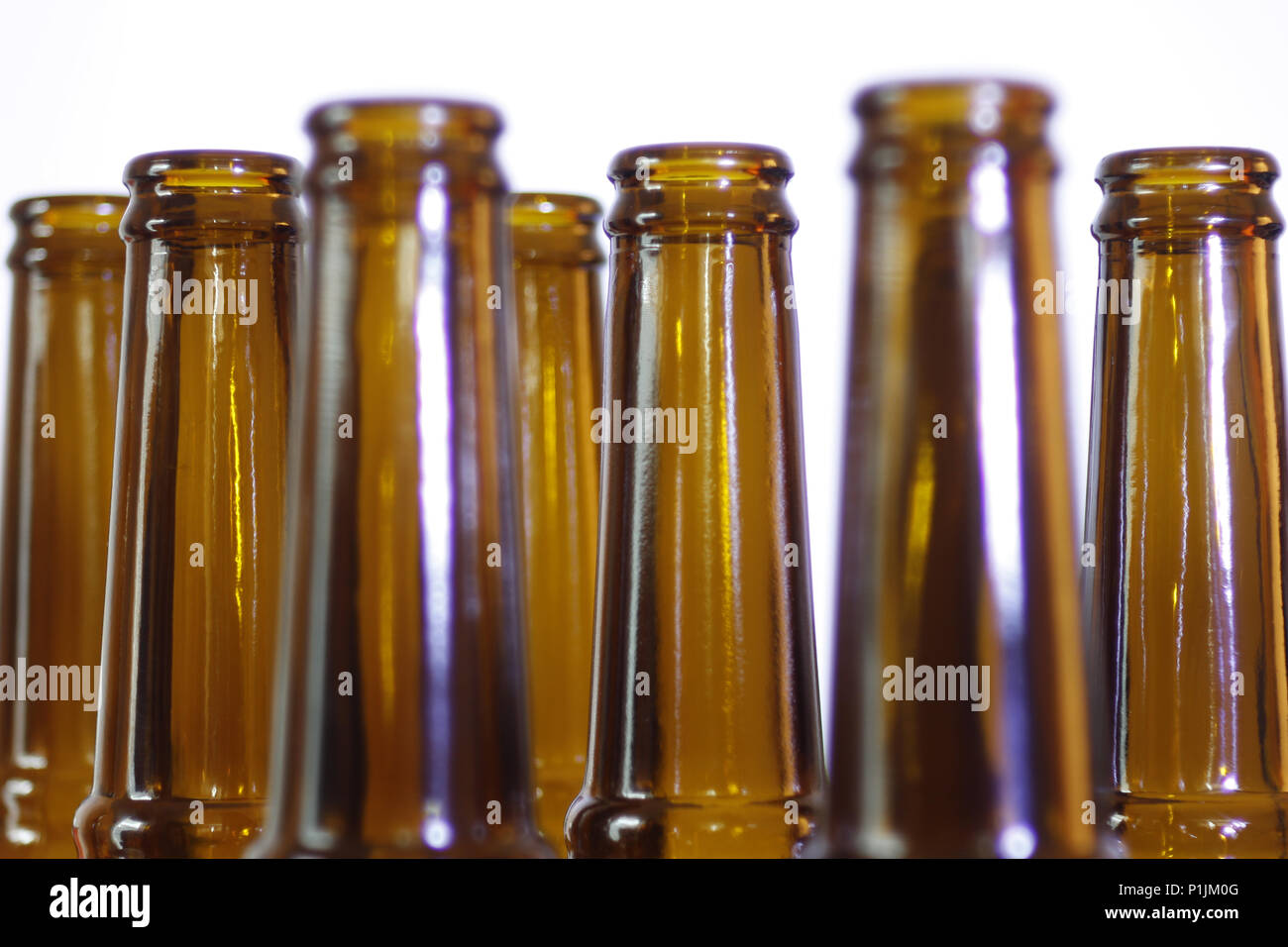 Frontal view of the top part of several beer bottles Stock Photo - Alamy