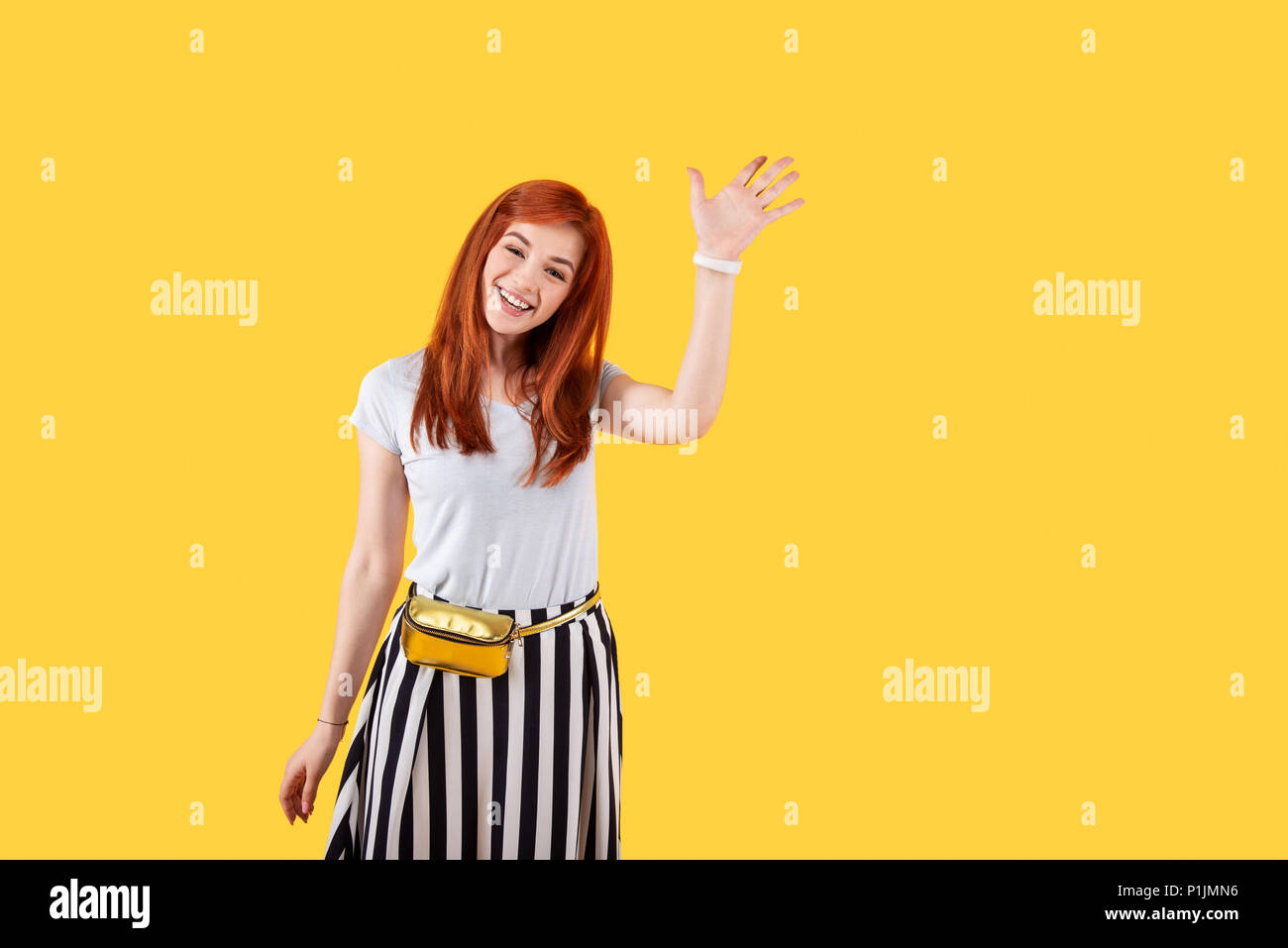 Cheerful delighted woman greeting you Stock Photo - Alamy