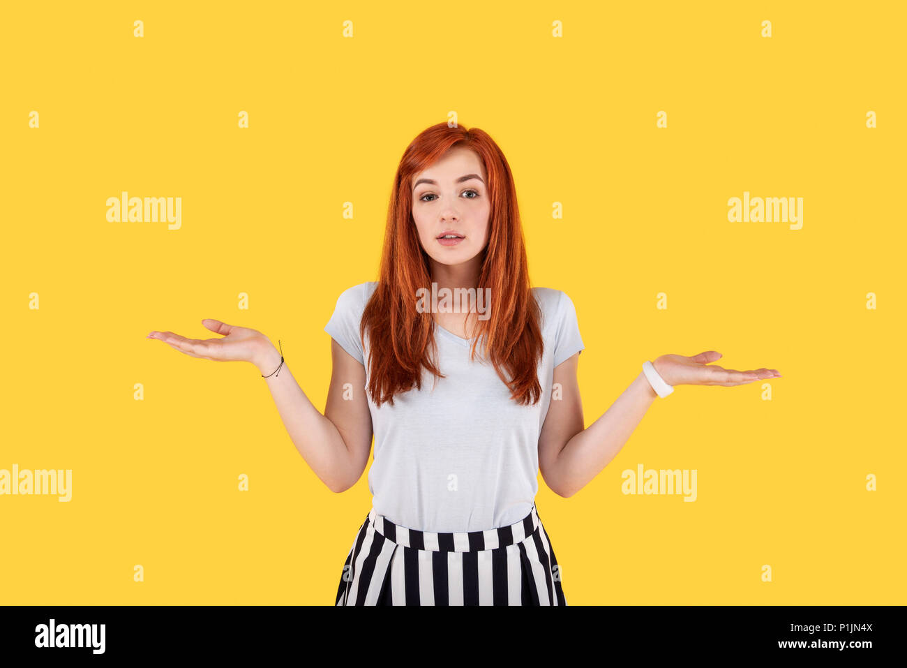 Pleasant young woman looking at you Stock Photo - Alamy
