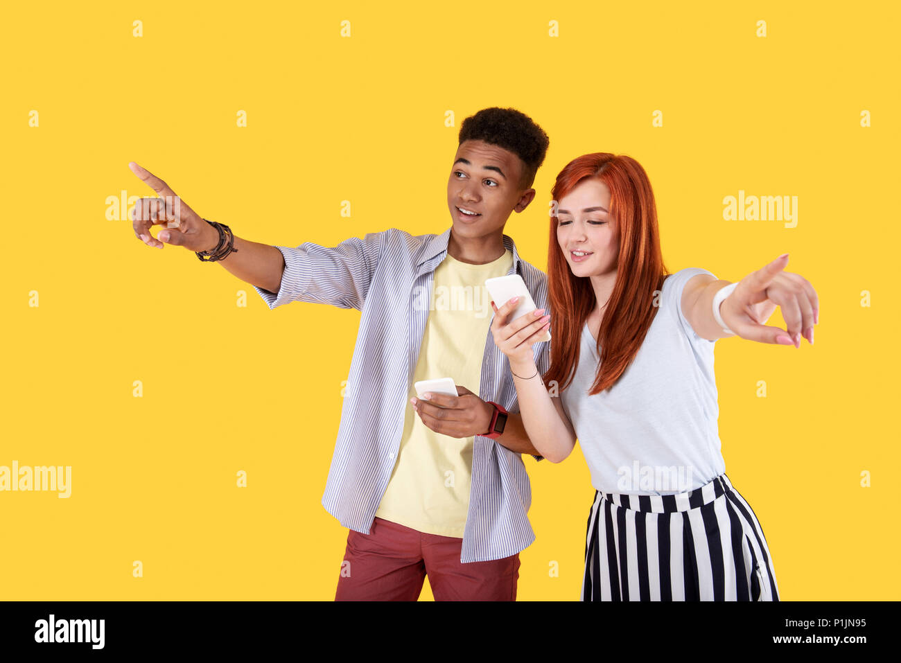 Cheerful positive people looking for the way Stock Photo - Alamy