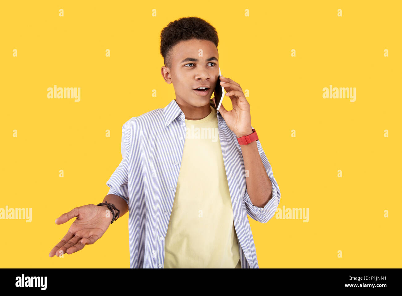 Nice handsome man having a phone conversation Stock Photo - Alamy