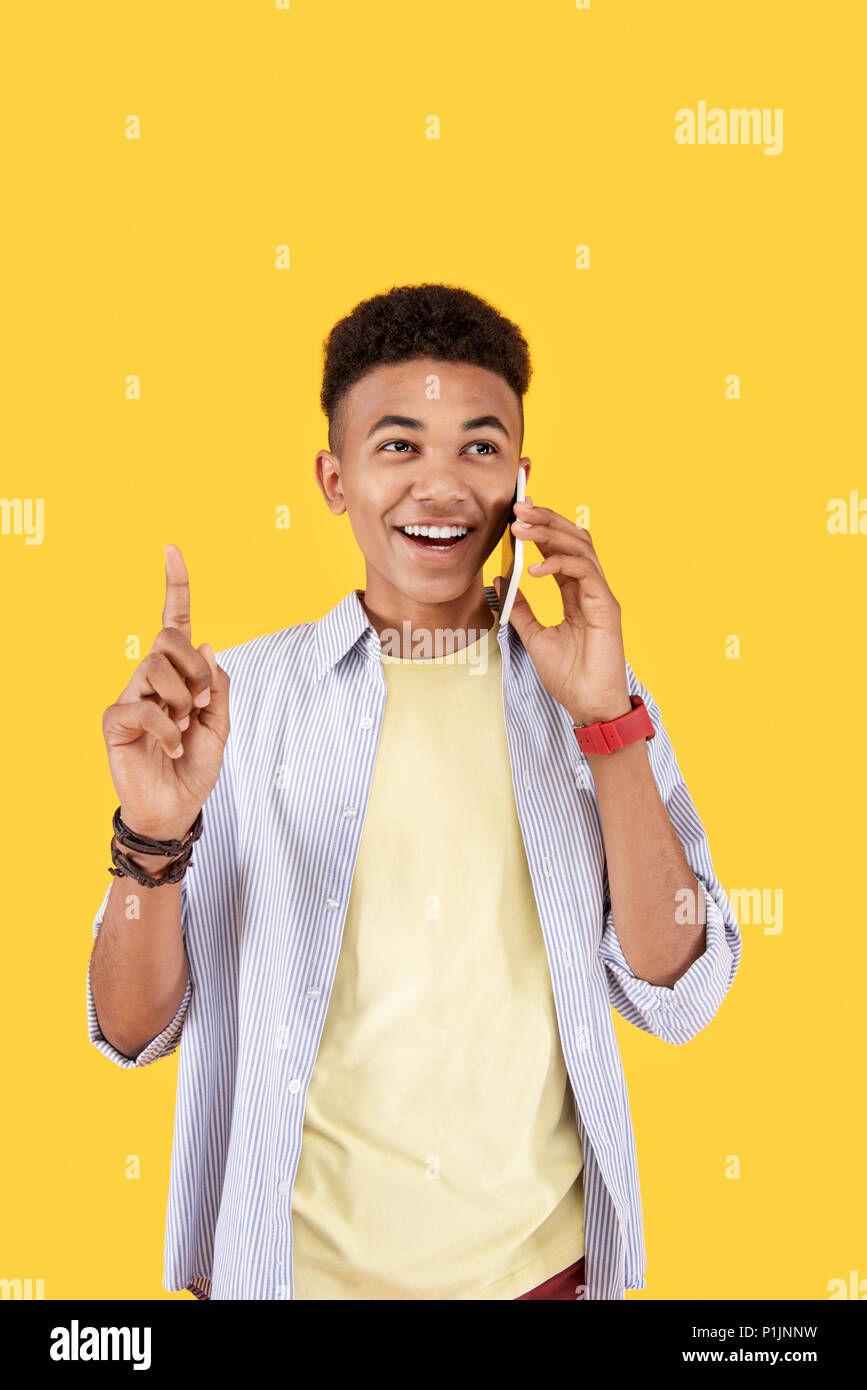 Nice happy man pointing up with his finger Stock Photo - Alamy