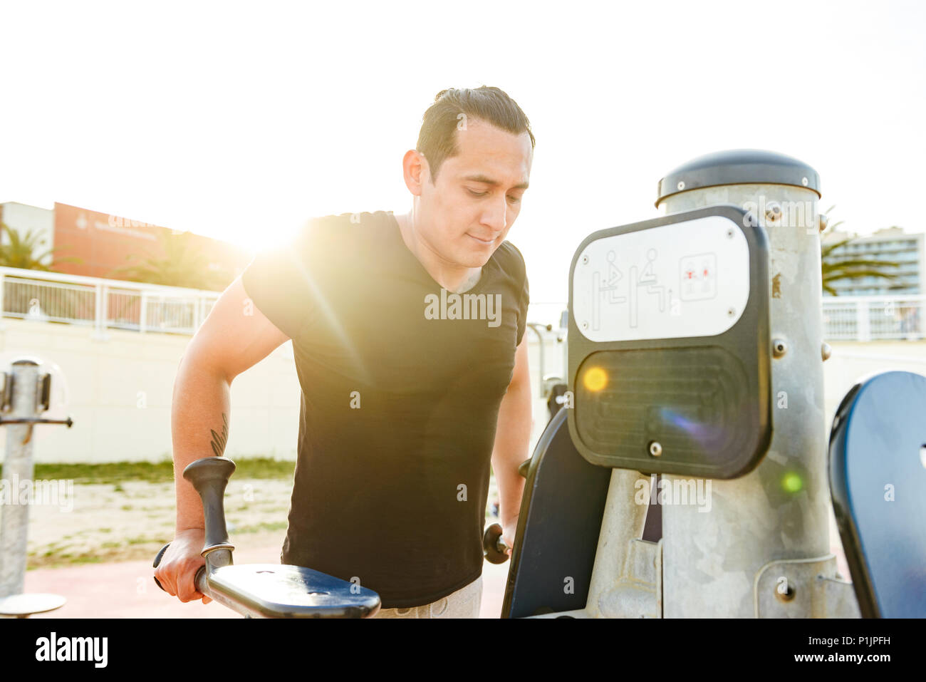 Photo of concentrated handsome young strong sports man outdoors make ...