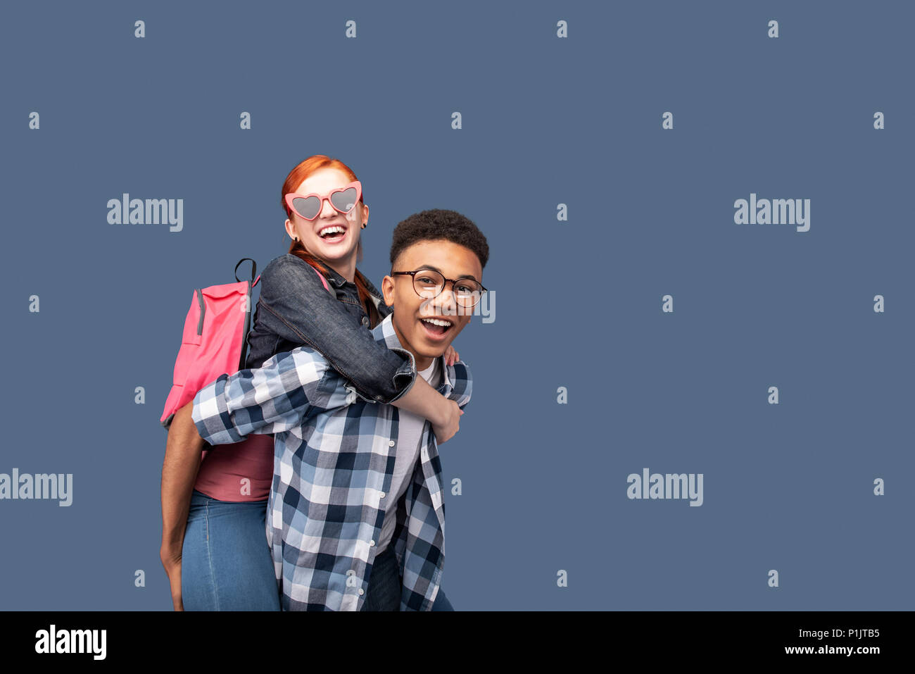 Joyful happy man carrying his friend Stock Photo - Alamy