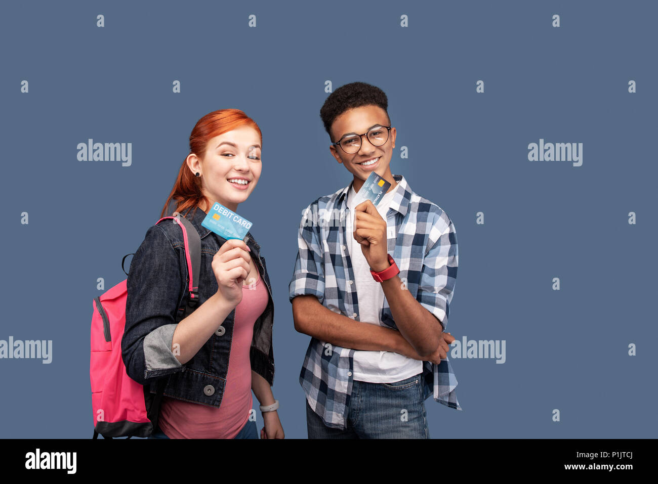 Happy nice people holding their debit cards Stock Photo - Alamy