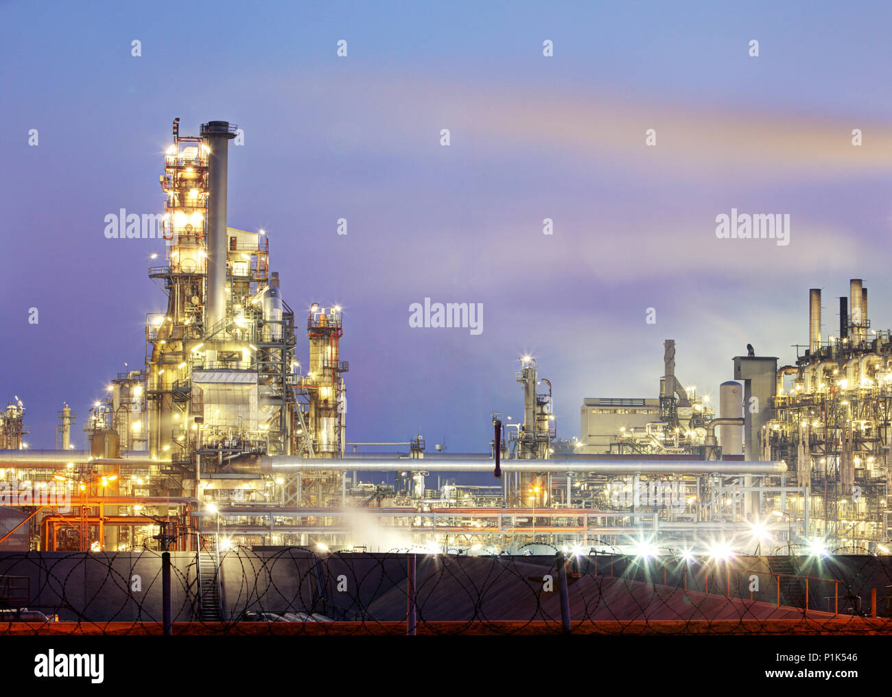 Petrochemical plant at night, oil and gas industrial Stock Photo - Alamy