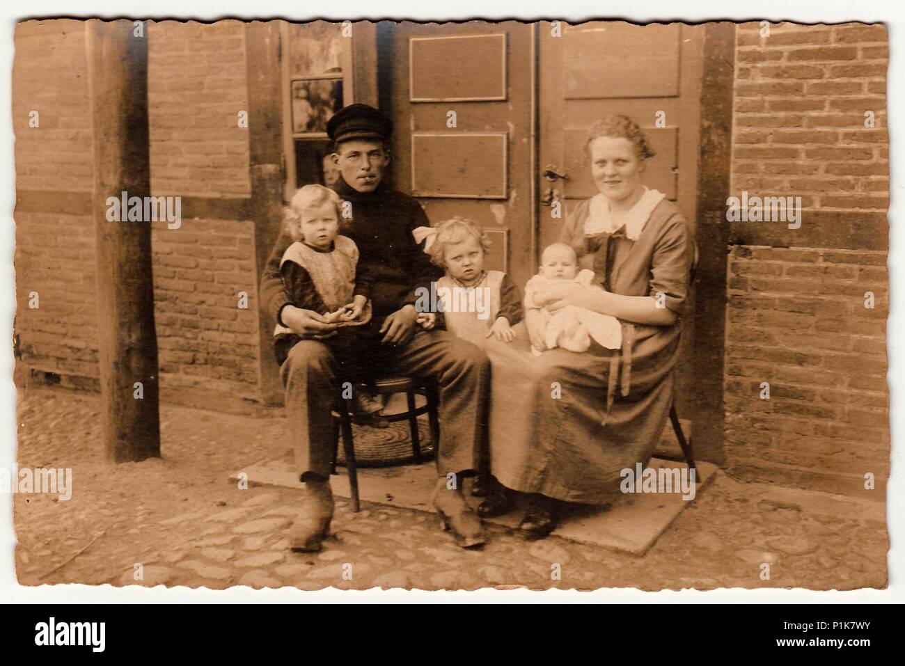 GERMANY - CIRCA 1930s: Vintage photo shows rural family sits in front ...