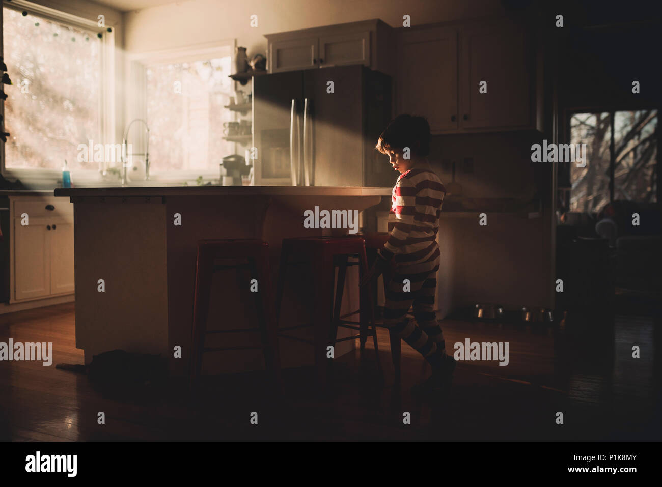 Boy standing in the kitchen dancing Stock Photo - Alamy