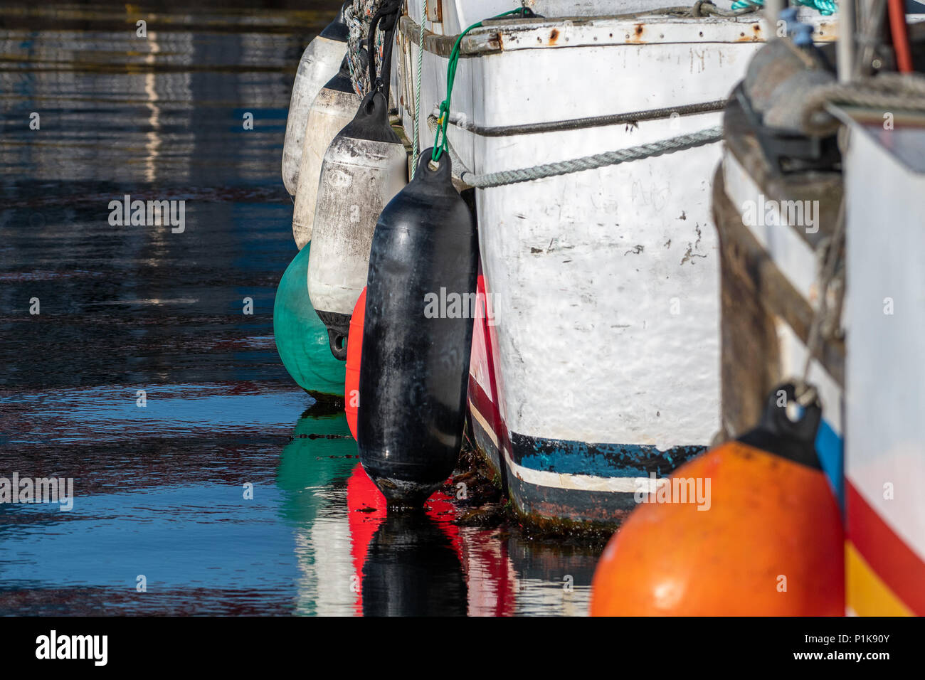 Floats hanging on boats in a harbor Stock Photo - Alamy