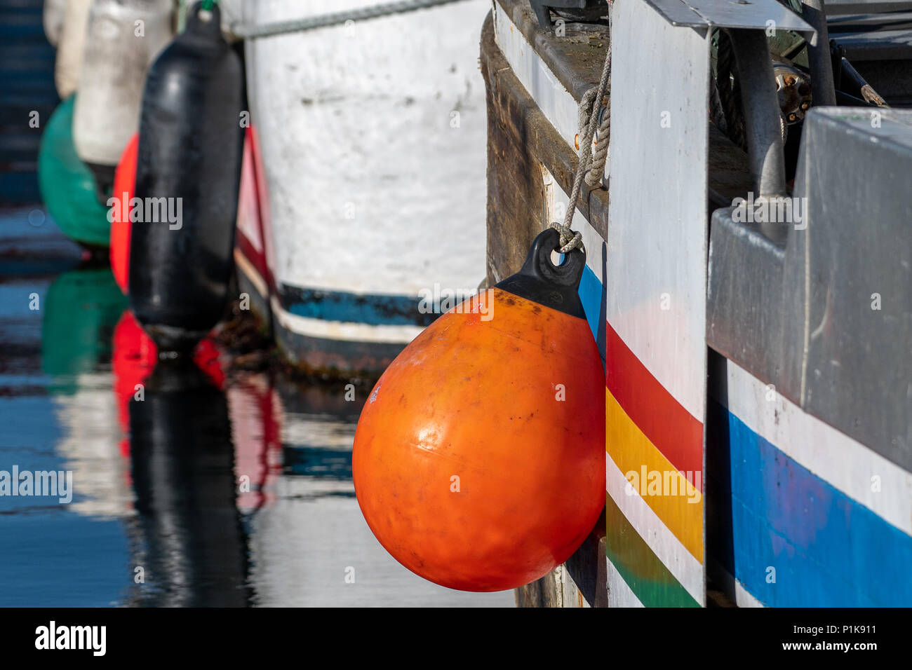 Floats hanging on boats in a harbor Stock Photo - Alamy
