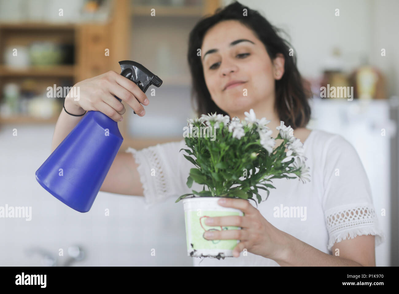 Young cheerful woman watering flower hi-res stock photography and ...
