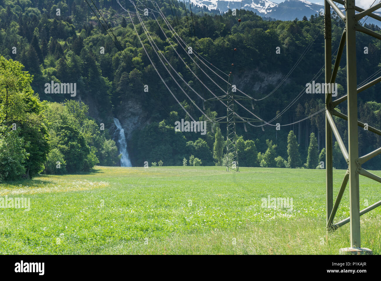 power lines and electricity cables leading to a mountain side with a ...