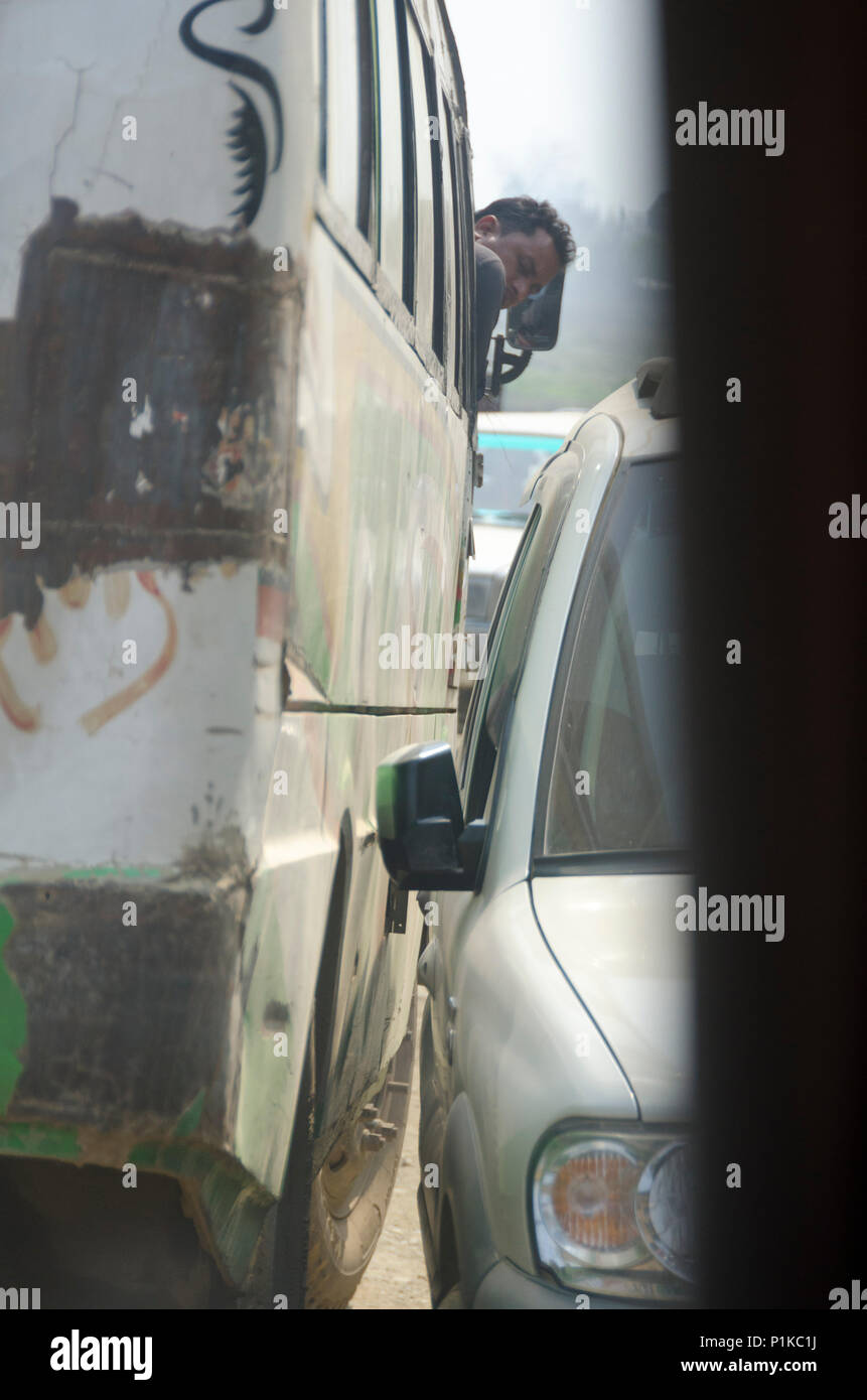 Car passing very close to bus on narrow road, Trishuli Valley, near ...