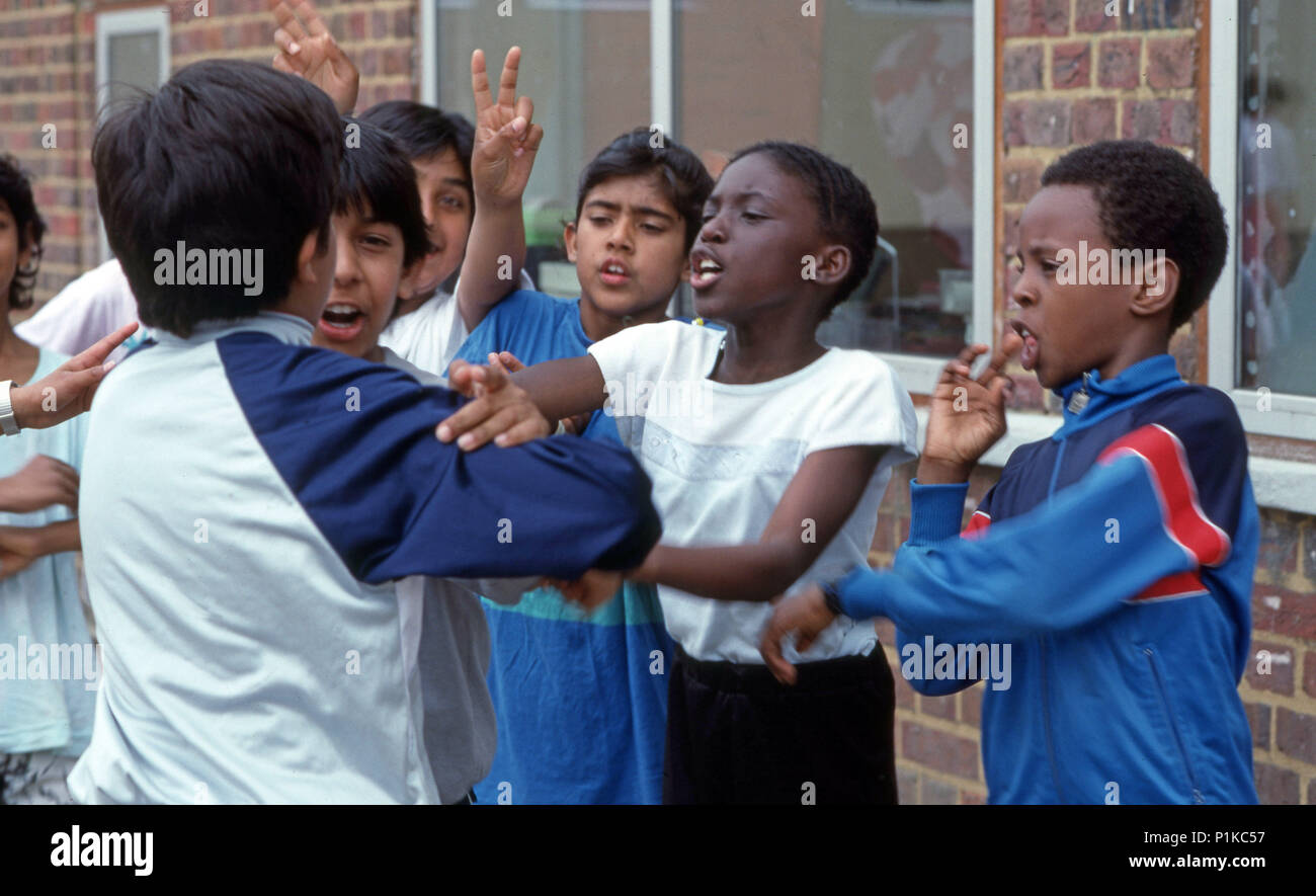 Primary school playground multi racial children arguing Stock Photo - Alamy