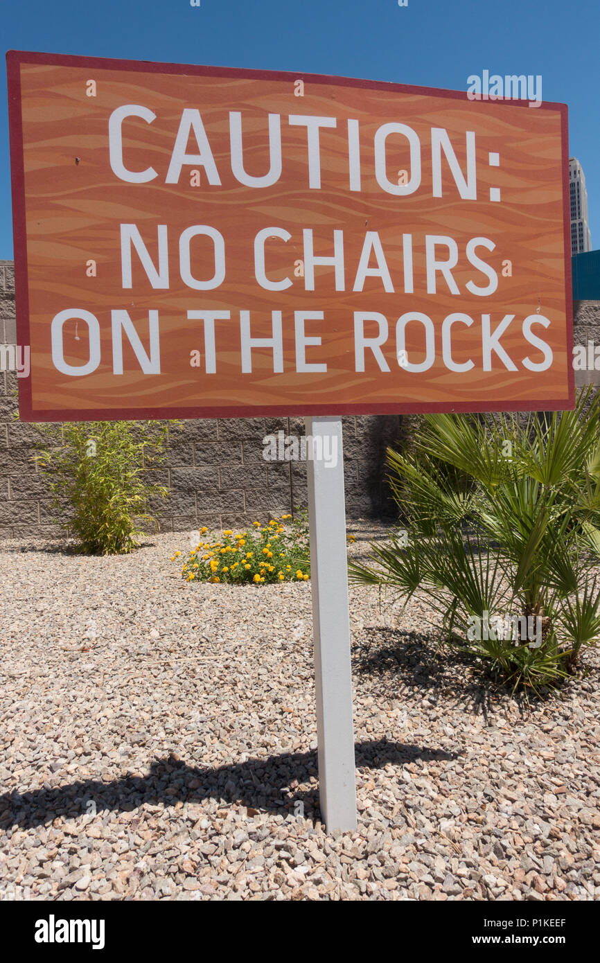 Caution sign no chairs on the rocks Stock Photo - Alamy