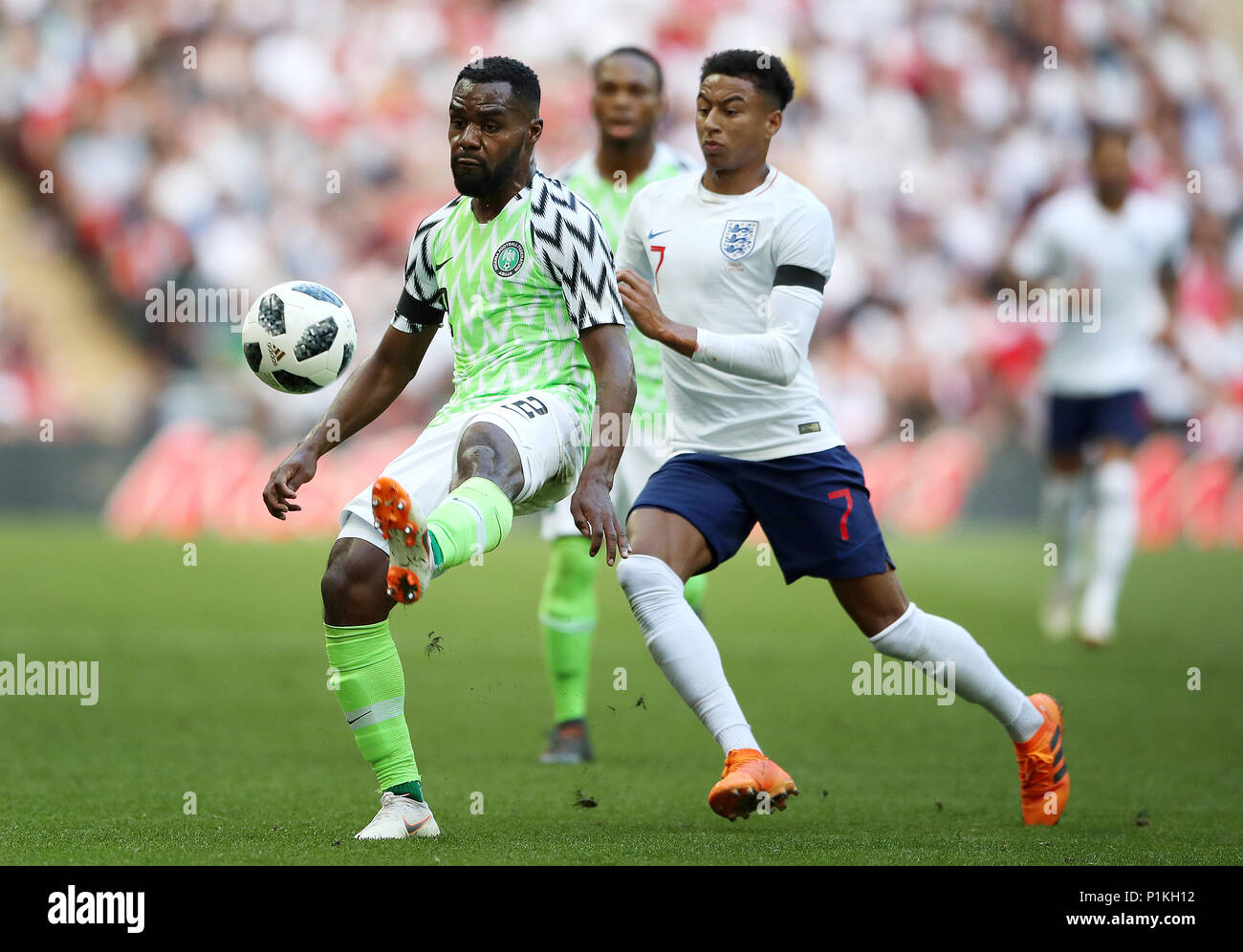 Nigeria's Brian Idowu (left) and England's Jesse Lingard (right) battle ...