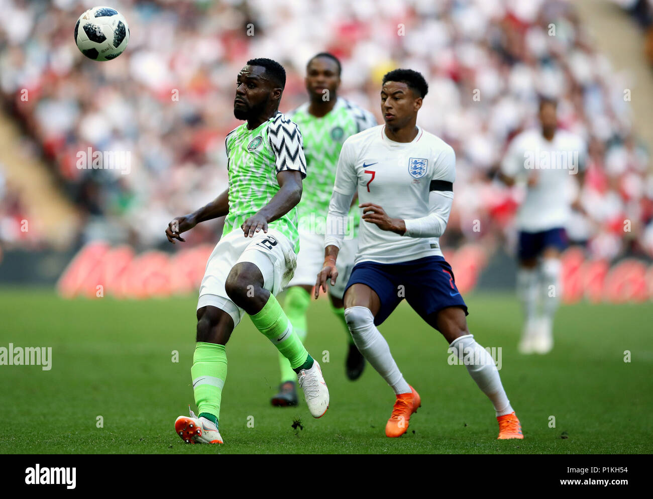 Nigeria's Brian Idowu (left) and England's Jesse Lingard (right) battle ...