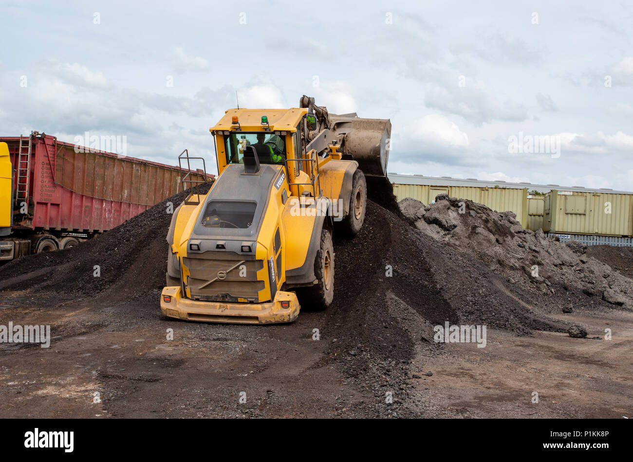A Wheel Loader Vehicle Moving a Large Pile of Gravel and Asphalt on ...