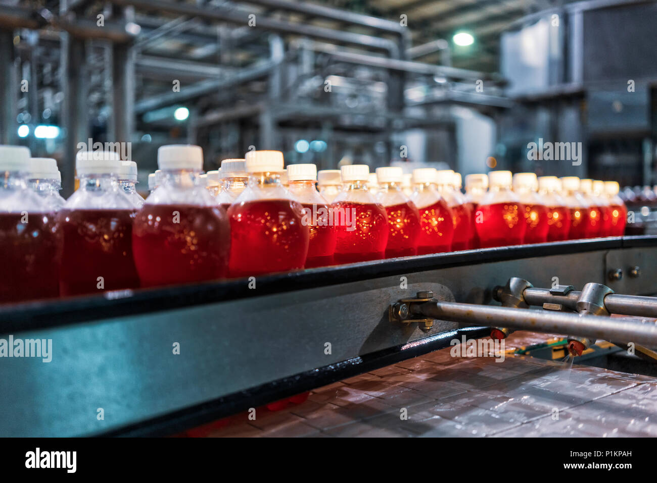 Bottles of red soda in the factory line Stock Photo - Alamy